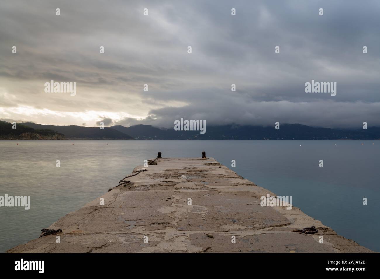 View of the stone dock leading out into the ocean at Enfola Beach on ...