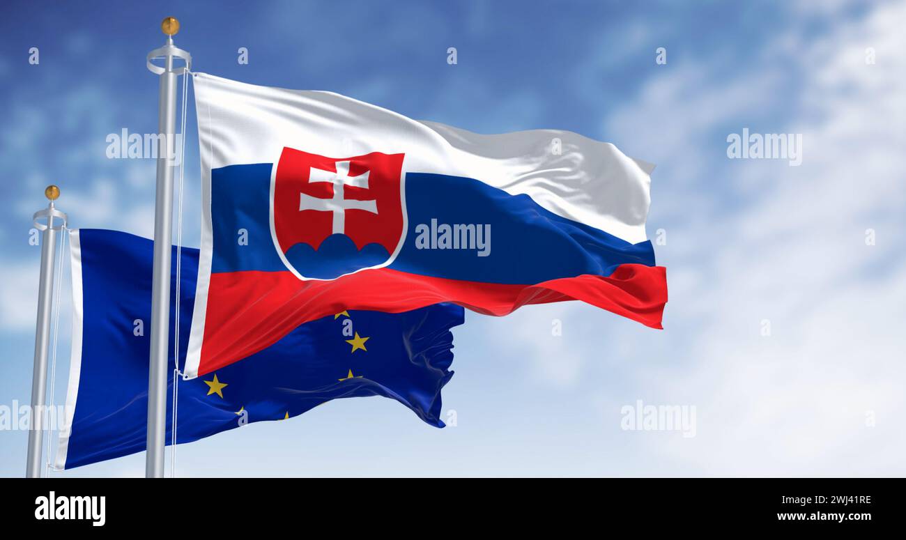 Slovakia and the European Union flags waving in the wind on a clear day ...