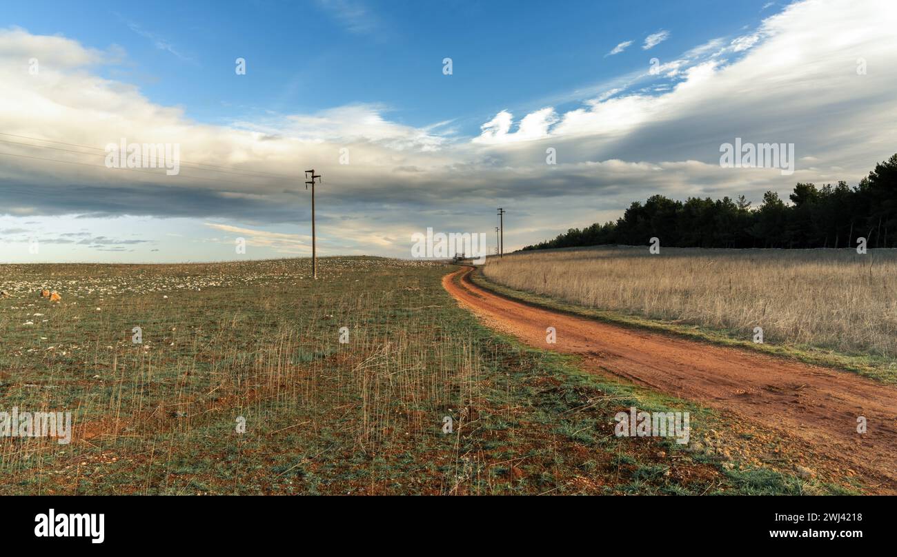 Red dirt road leading through the barren limestone fields of the Alta ...