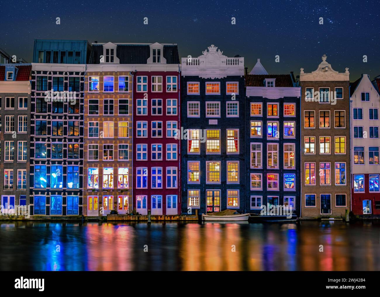 Amsterdam at night with dancing colorful house at the Amsterdam Stock ...