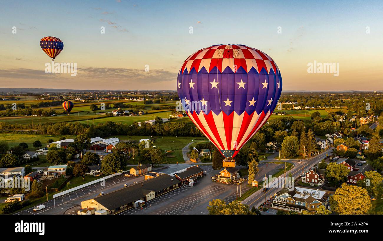 Aerial View of Multiple Hot Air Balloons Floating Away in Rural ...