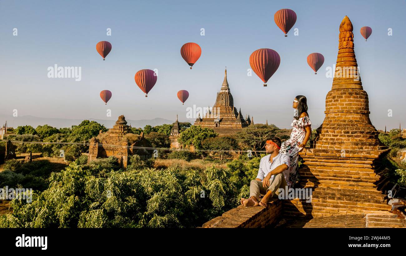 Bagan Myanmar, couple of men and woman looking at the sunrise on top of ...