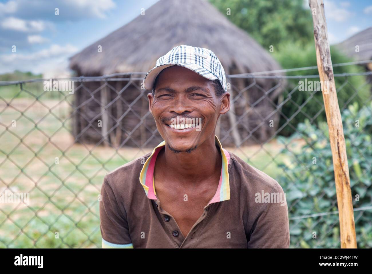 village african man portrait, standing outside in the yard, wattle ...
