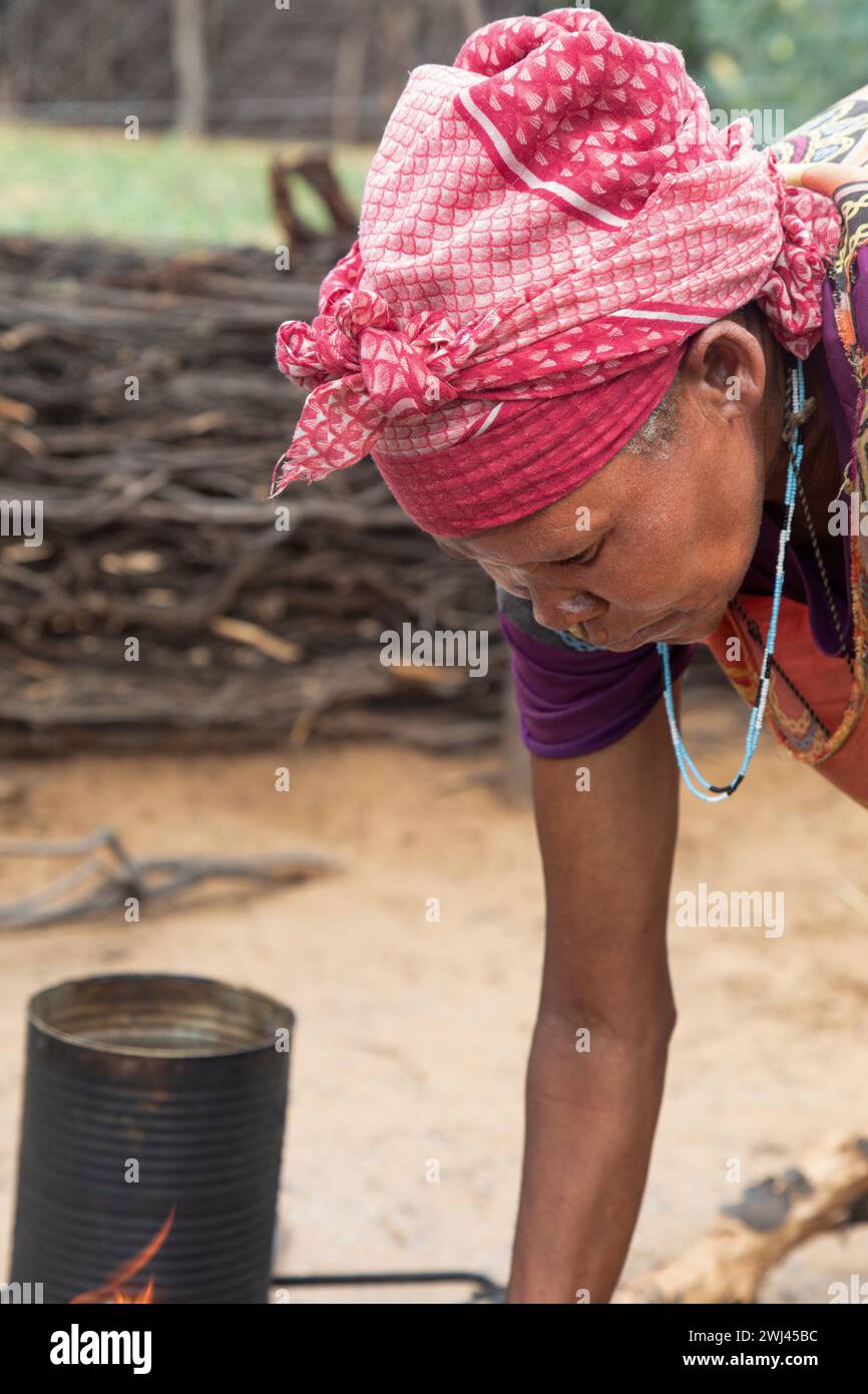 village african old woman portrait, cooking in the outdoors kitchen ...