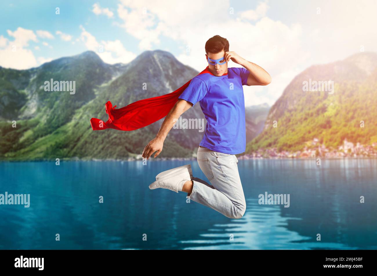 Superhero, motivation and power. Man in cape and mask over lake in ...