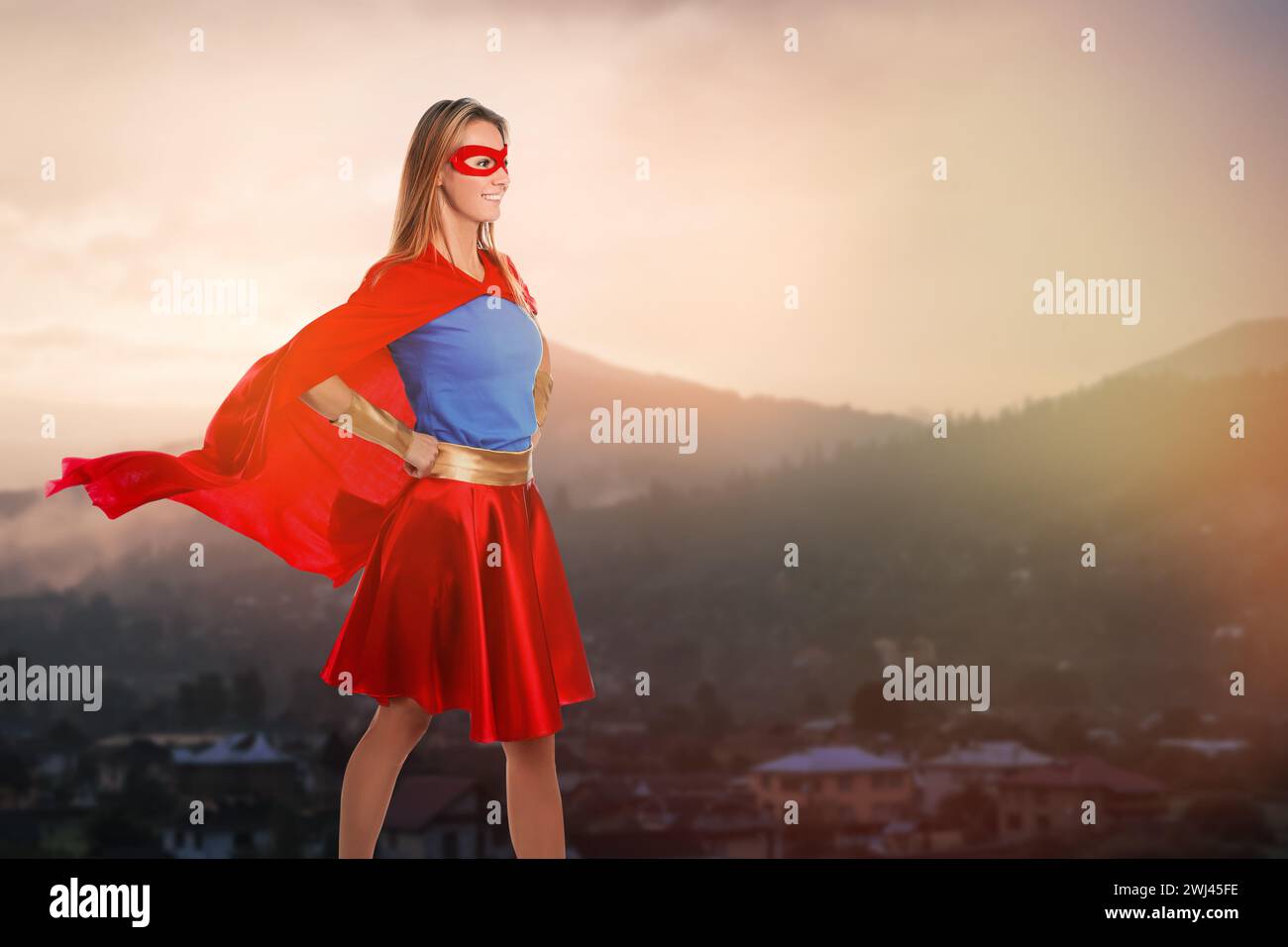 Superhero, motivation and power. Woman in cape and mask on high top in ...