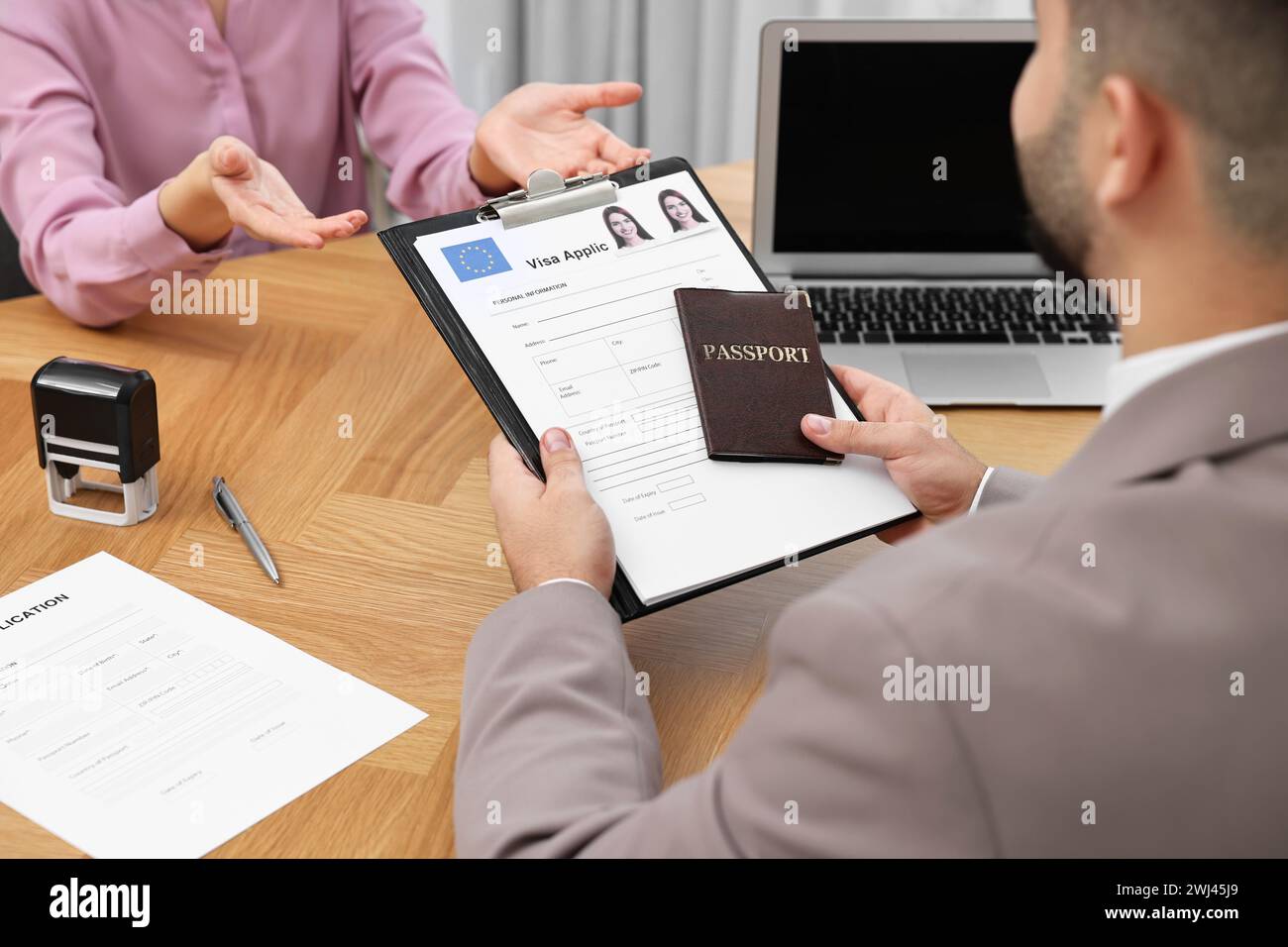 Immigration to European Union. Embassy worker giving visa application ...