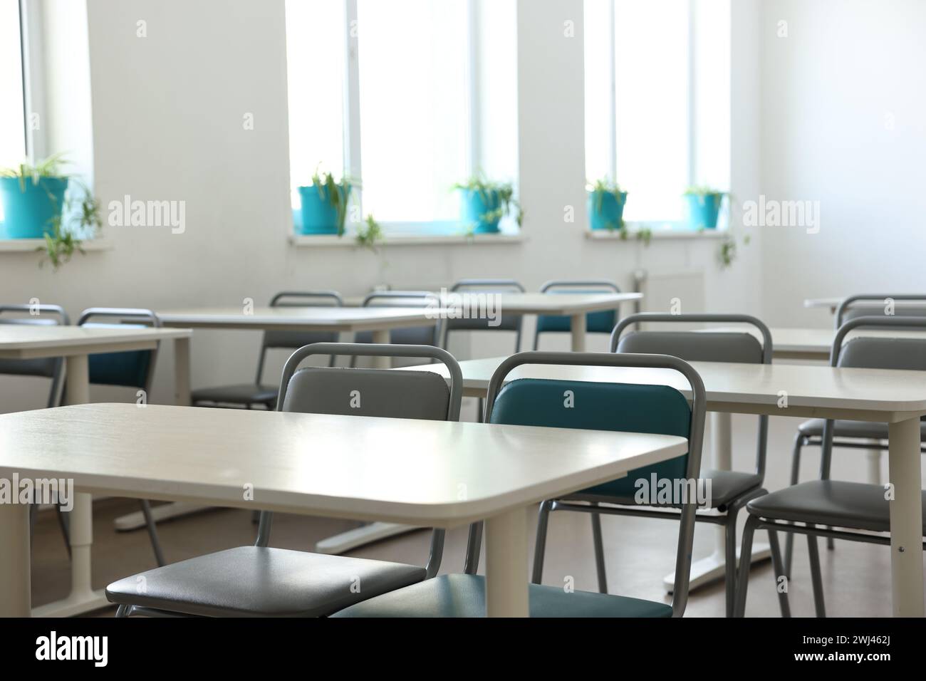 Empty school classroom with desks, windows and chairs Stock Photo - Alamy