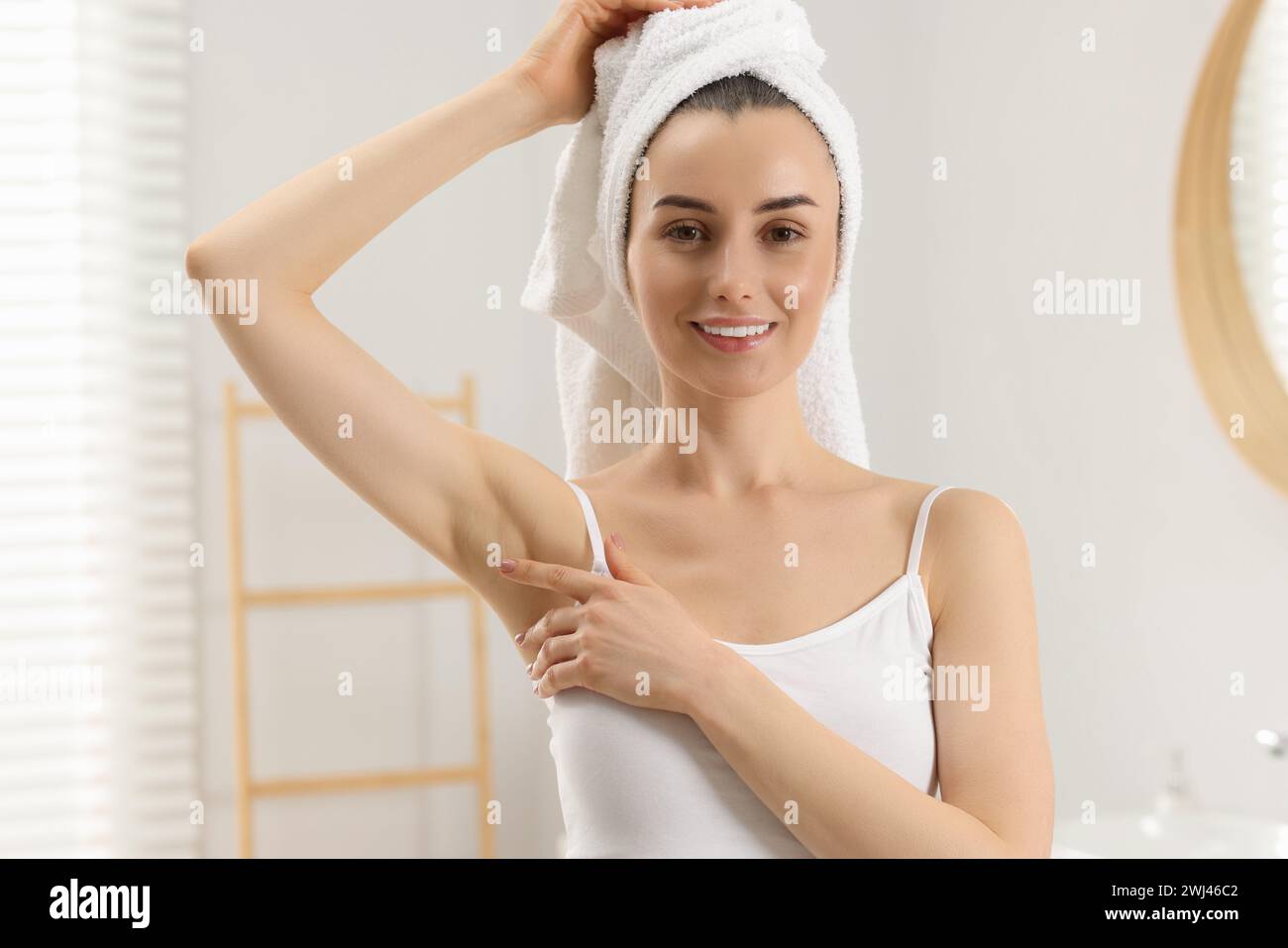 Beautiful woman showing armpit with smooth clean skin in bathroom Stock ...
