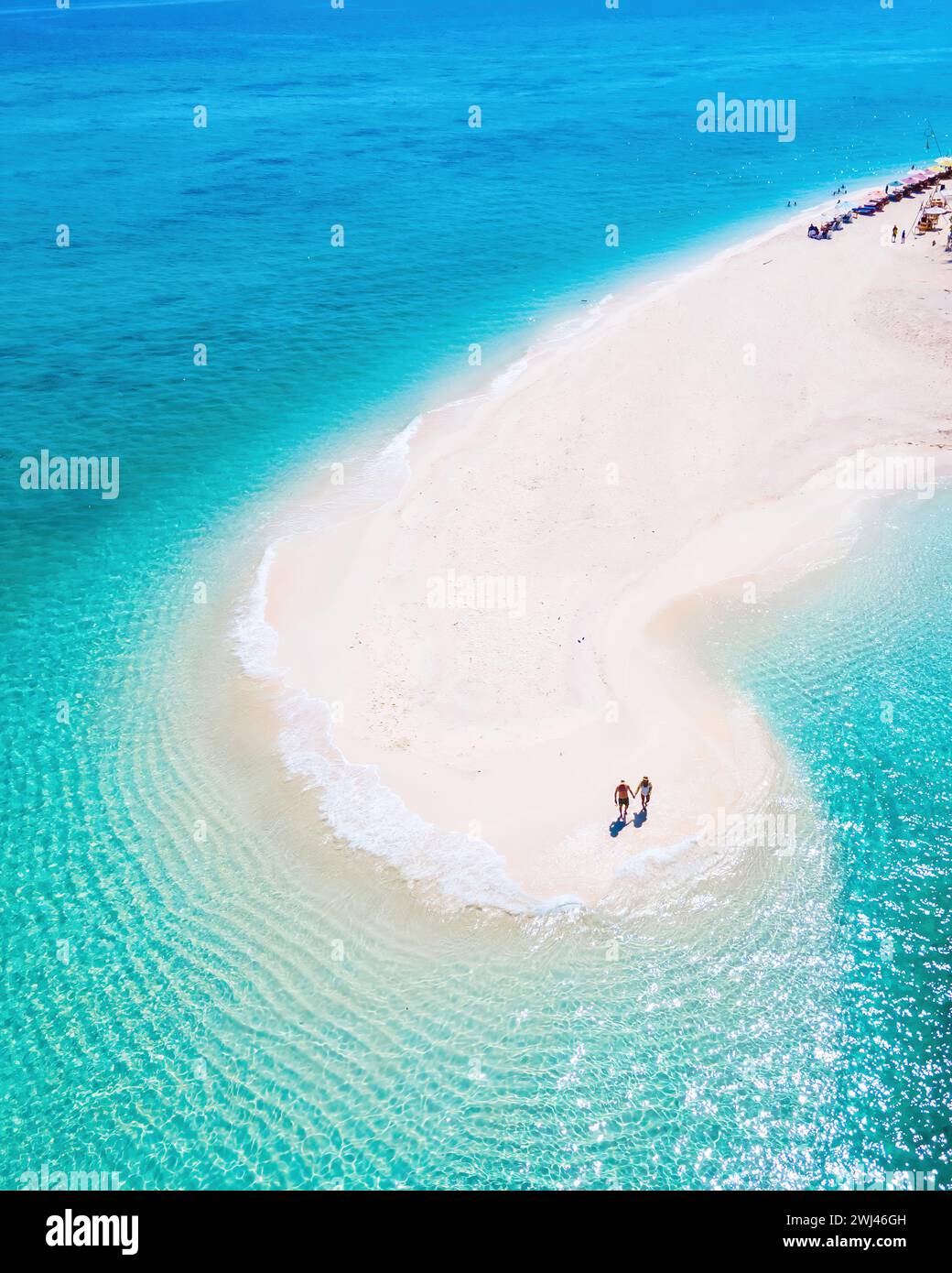 Men and women walking on a sandbar in the ocean of Koh lipe Southern Thailand during vacation ...