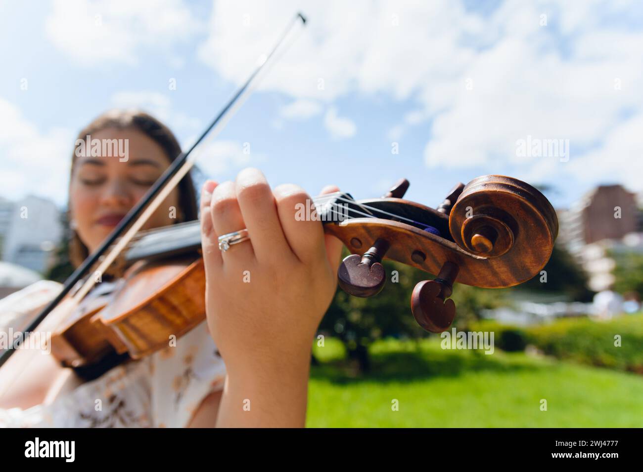 Close-up wide angle image of blurred latin young busker woman playing ...
