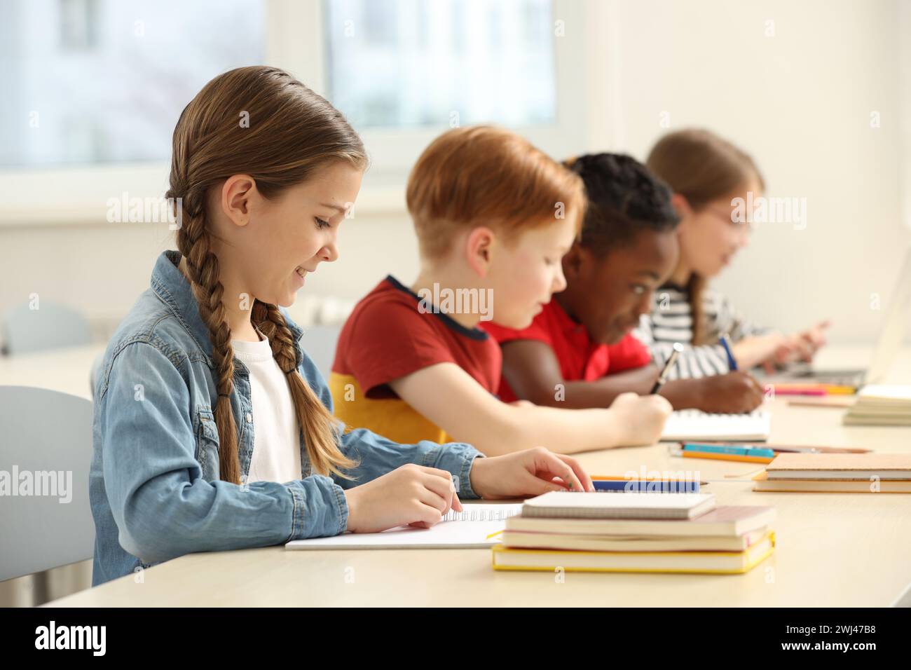 Cute children studying in classroom at school Stock Photo - Alamy