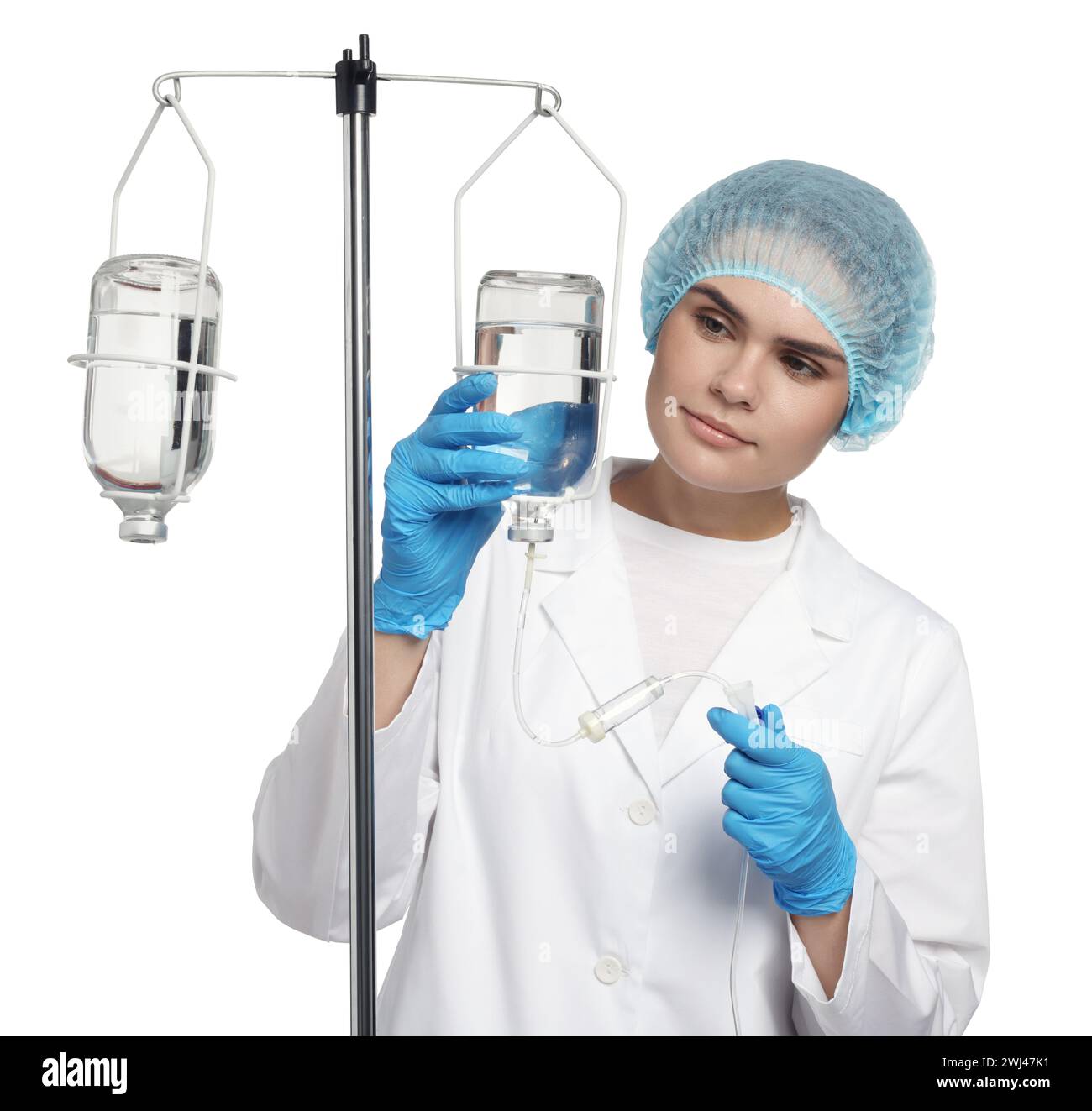 Nurse setting up IV drip on white background Stock Photo - Alamy