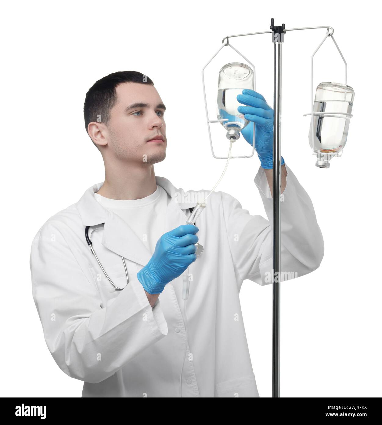 Doctor setting up IV drip on white background Stock Photo - Alamy