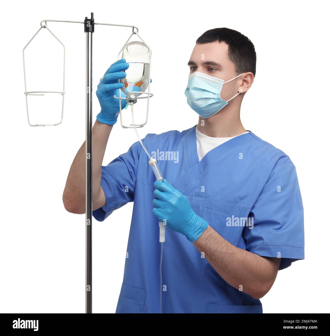 Nurse setting up IV drip on white background Stock Photo - Alamy