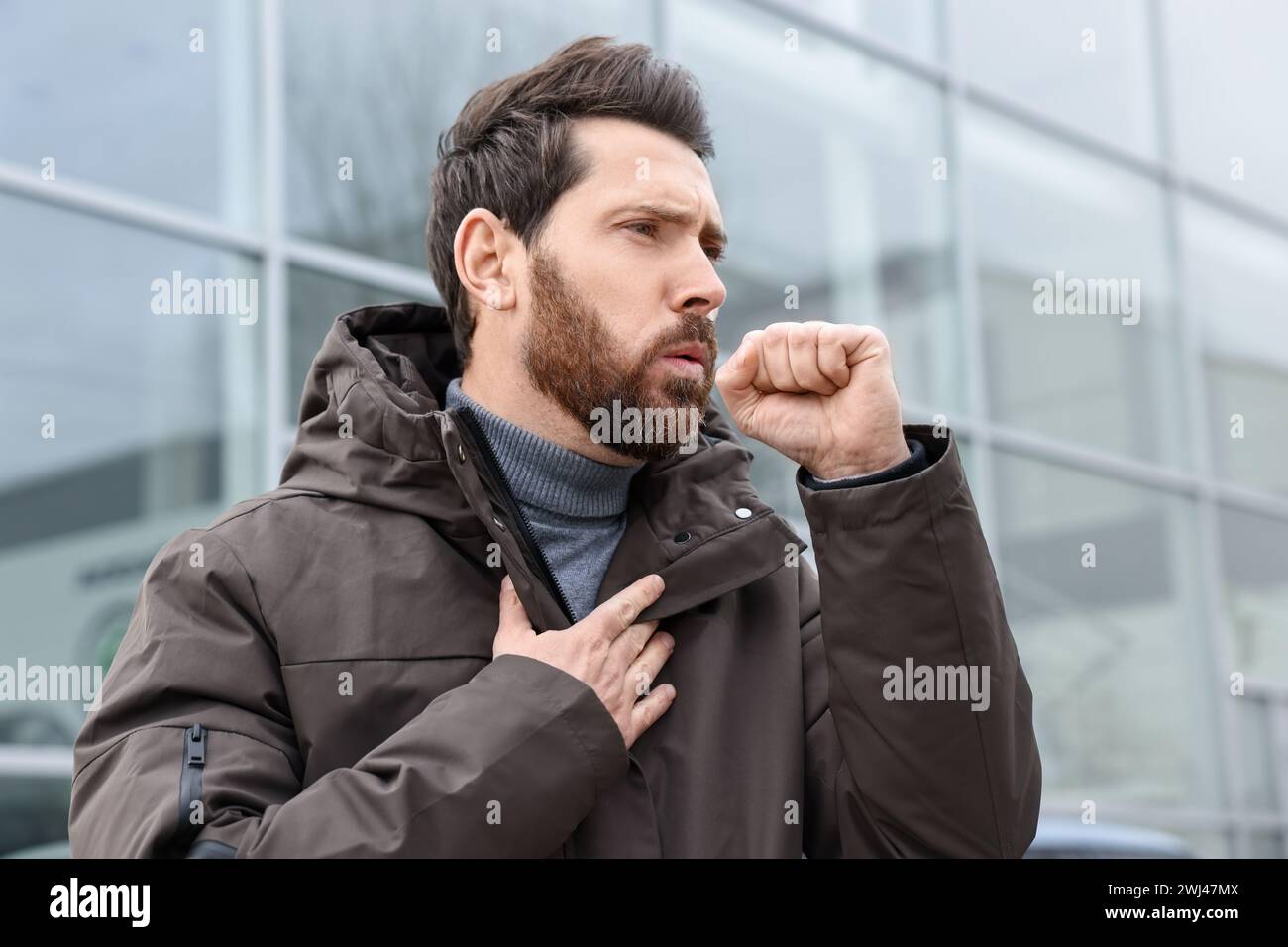 Sick man coughing on city street. Cold symptoms Stock Photo - Alamy