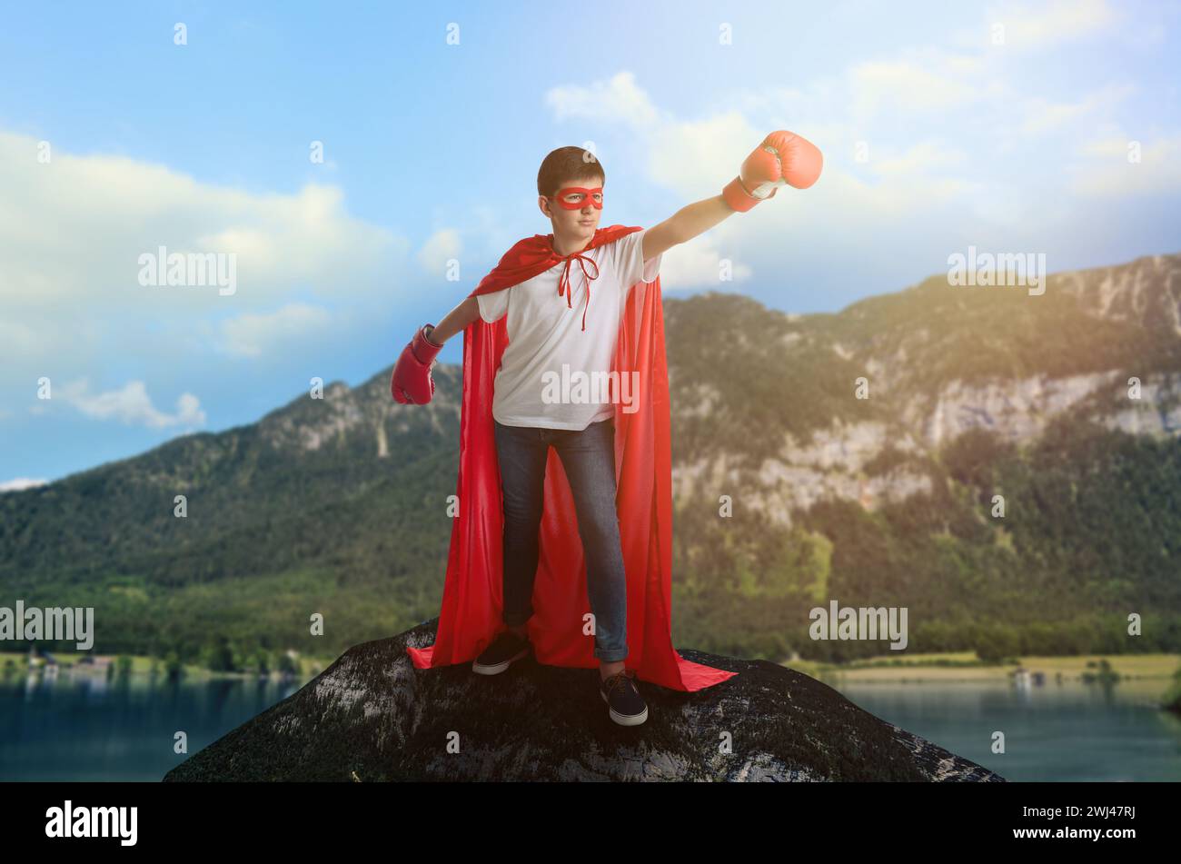 Superhero, motivation and power. Boy in cape and mask wearing boxing ...