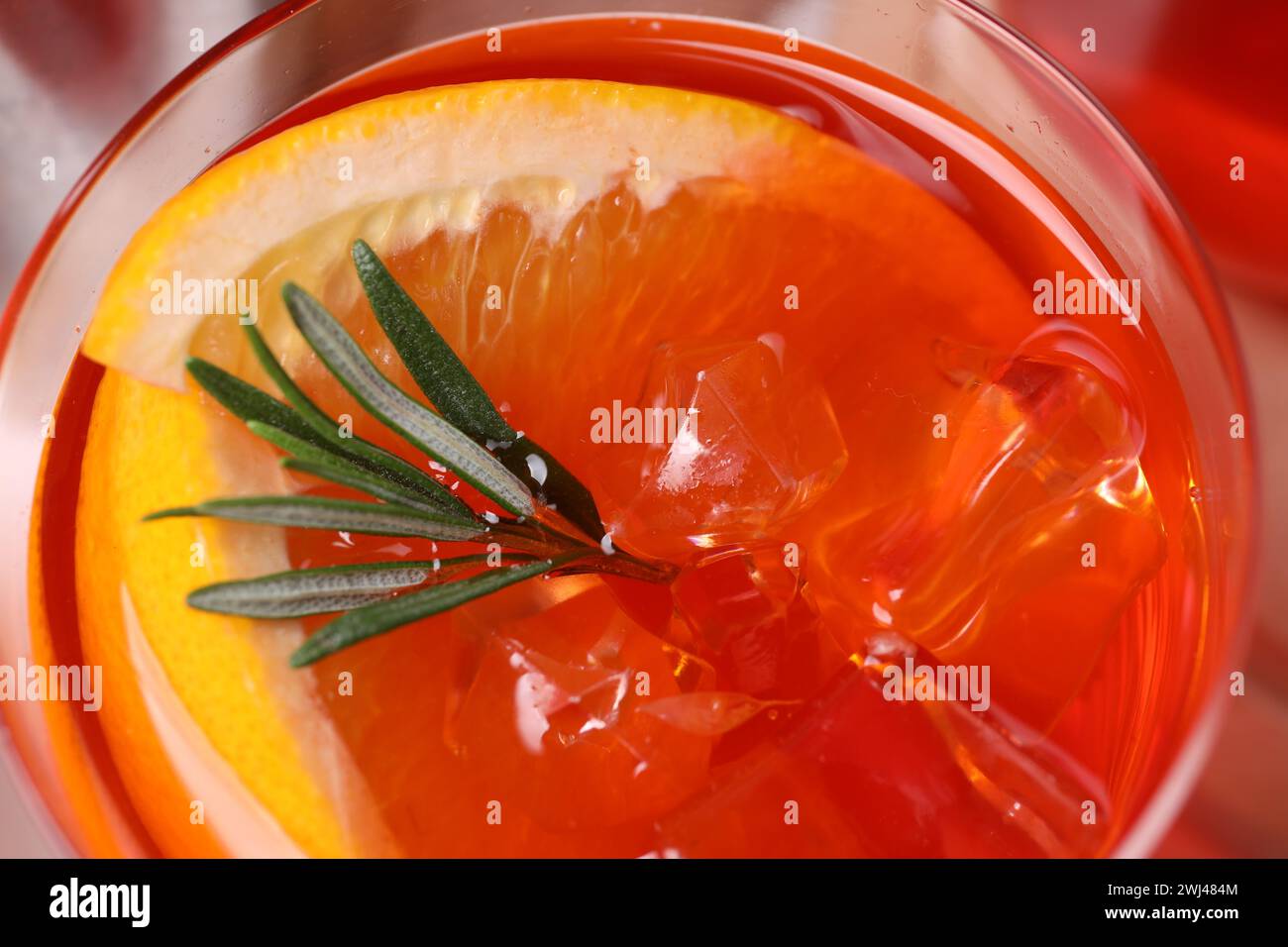 Aperol spritz cocktail, ice cubes, rosemary and orange slices in glass ...
