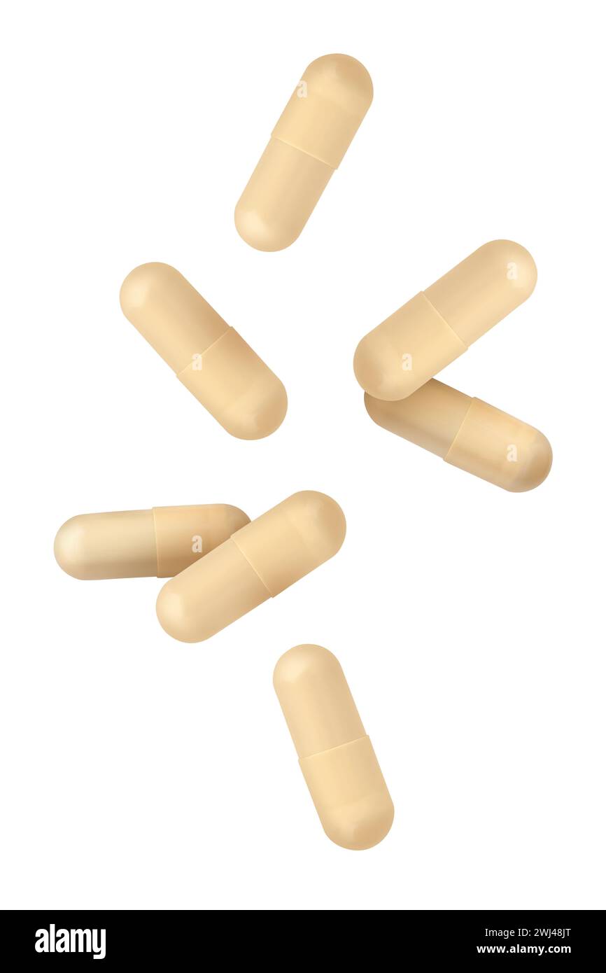 Vitamin. Many capsules falling on white background Stock Photo - Alamy