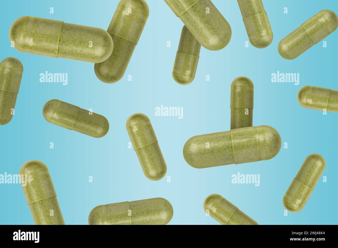 Vitamin. Capsules falling on light blue gradient background Stock Photo ...