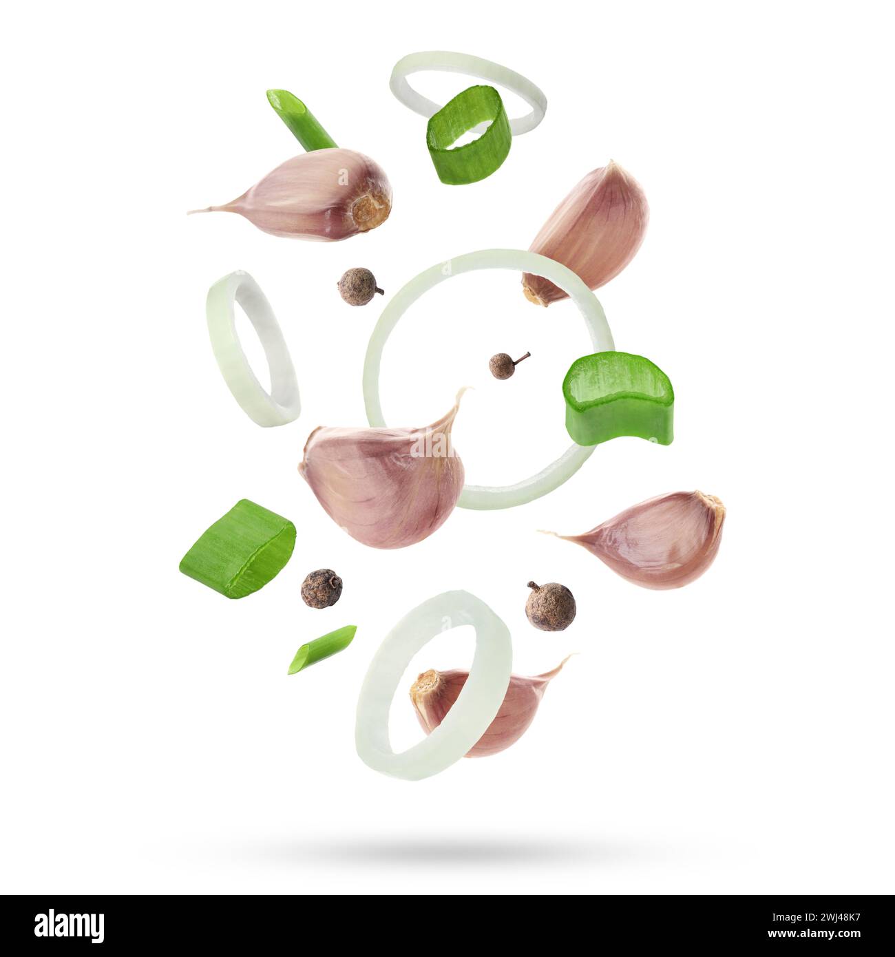 Different aromatic spices falling on white background Stock Photo - Alamy