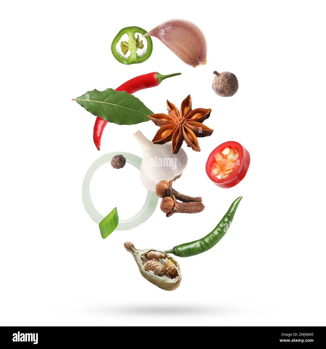 Different aromatic spices falling on white background Stock Photo - Alamy