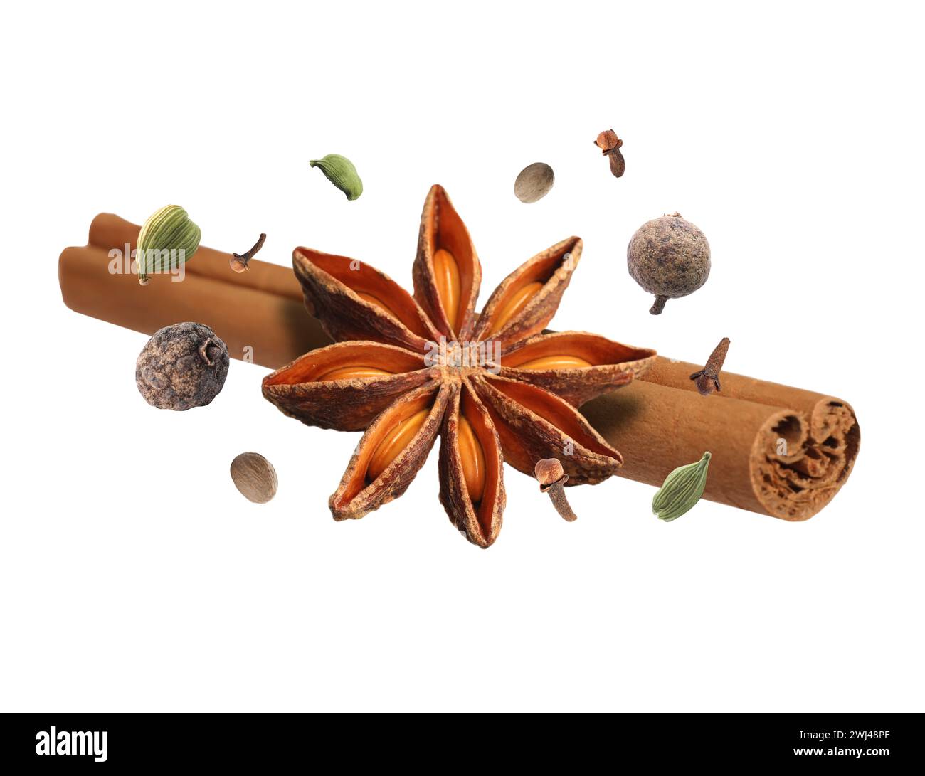 Different aromatic spices falling on white background Stock Photo - Alamy