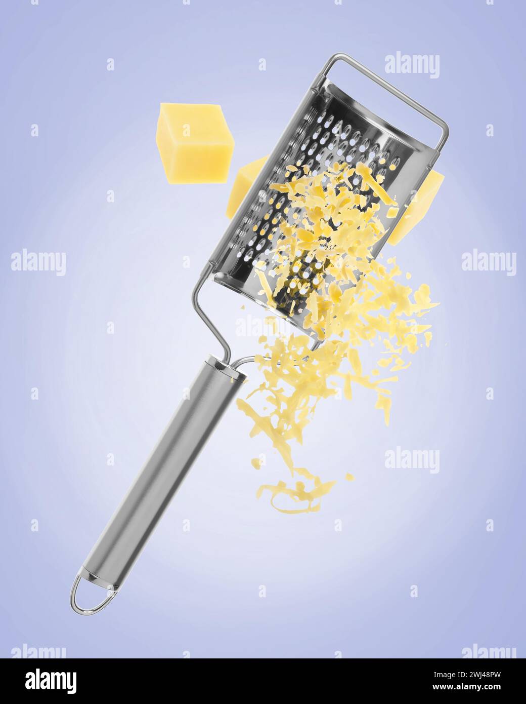 Grating cheese with hand grater on blue background Stock Photo - Alamy