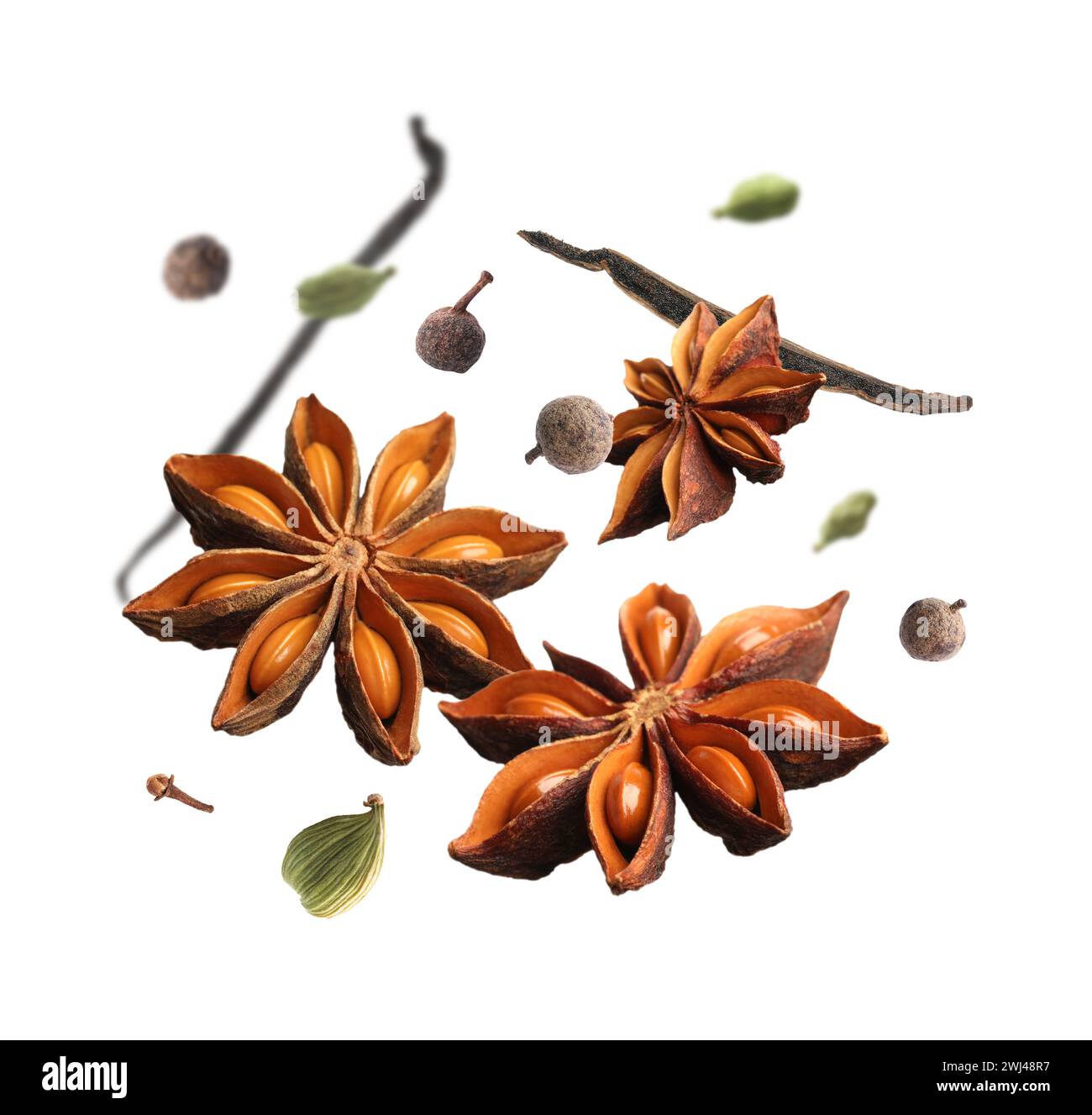 Different aromatic spices falling on white background Stock Photo - Alamy