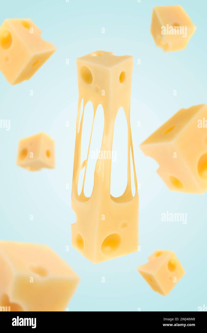 Pieces of cheese falling on light blue background Stock Photo - Alamy