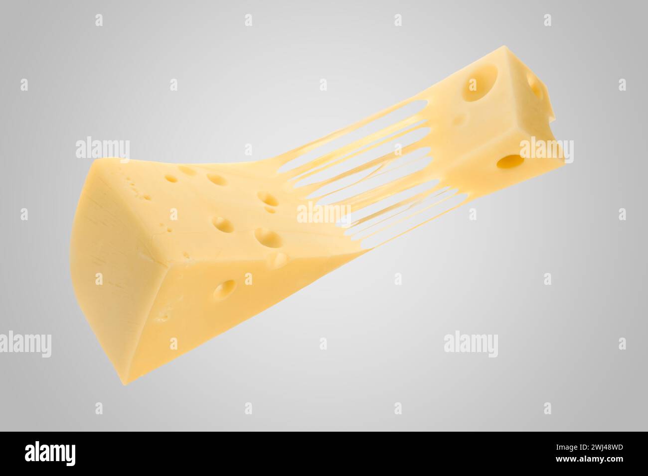 Tasty cheese stretching in air on grey background Stock Photo - Alamy