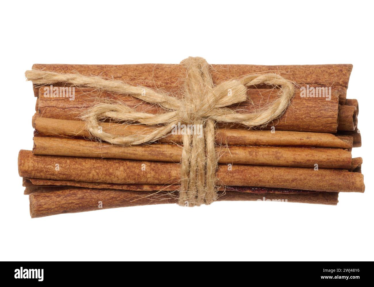 Dry cinnamon sticks tied with brown jute rope on a white isolated ...