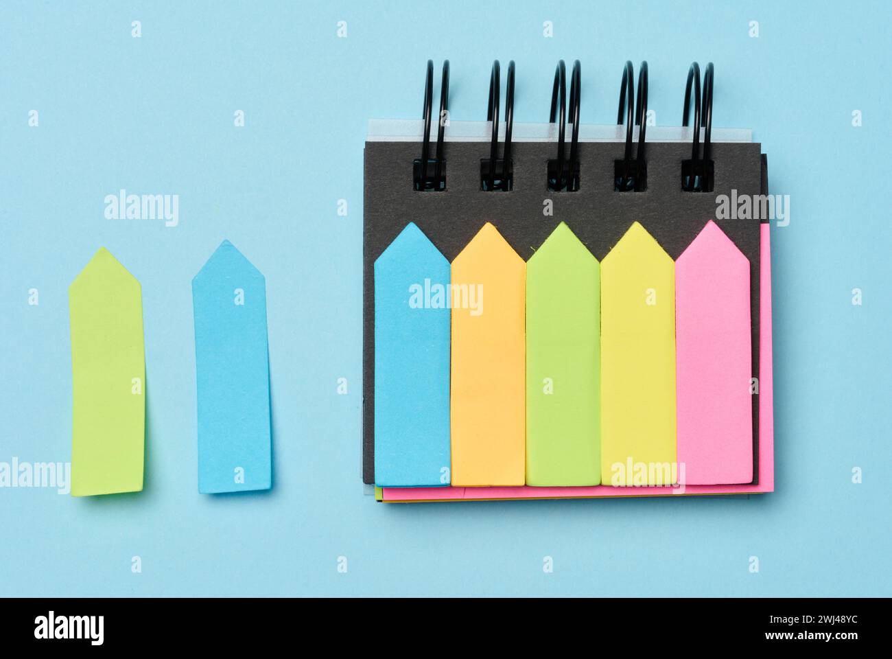 Multi-colored paper sticky notes on a blue background Stock Photo - Alamy