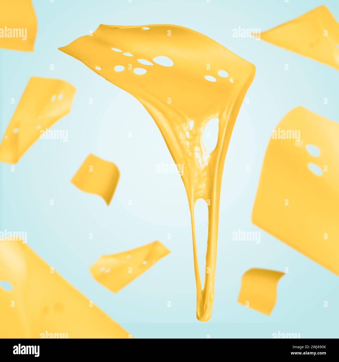 Slices of cheese falling on light blue background Stock Photo - Alamy