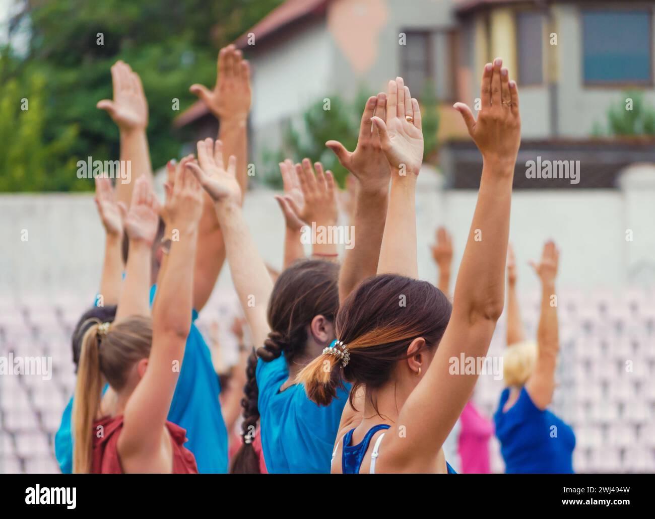 Group of women and girls with raised hands hi-res stock photography and ...