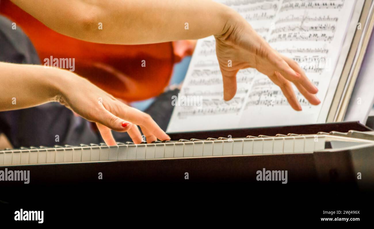 Female hands of a pianist musician and piano keys close up Stock Photo - Alamy