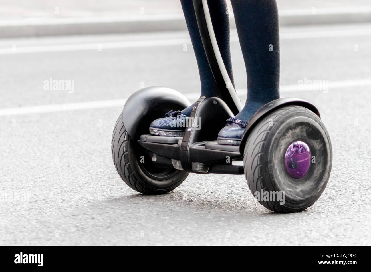Female legs on electric scooter on a city street close up Stock Photo ...