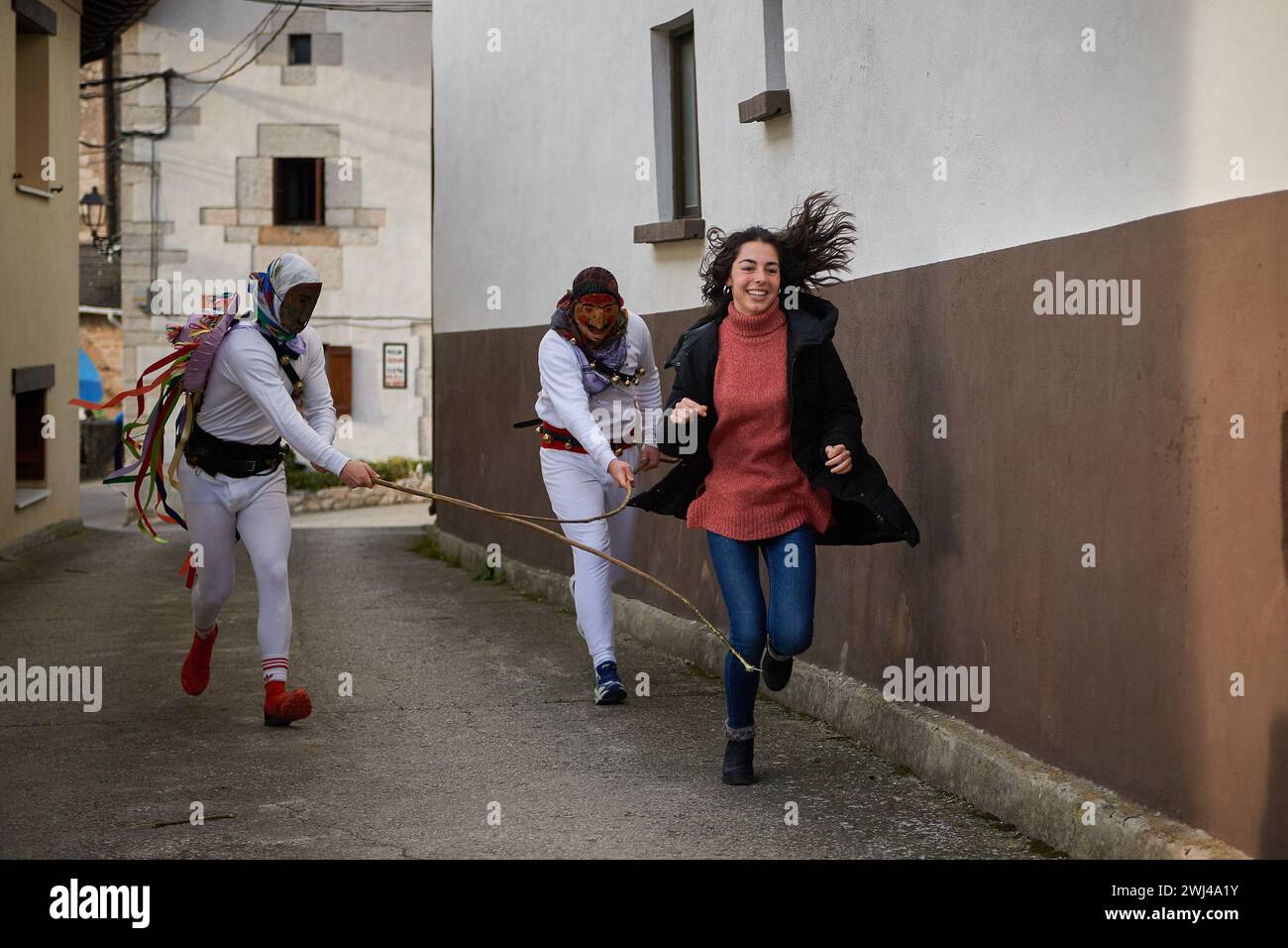 Two "mamuxarros" chase a young woman with their hazel sticks through ...