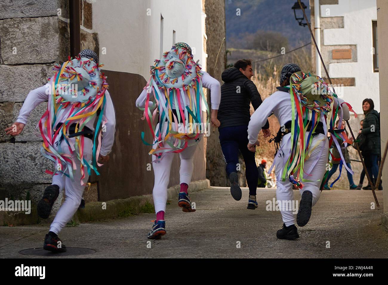 A young man is chased by three "mamuxarros" through the town of Unanua ...