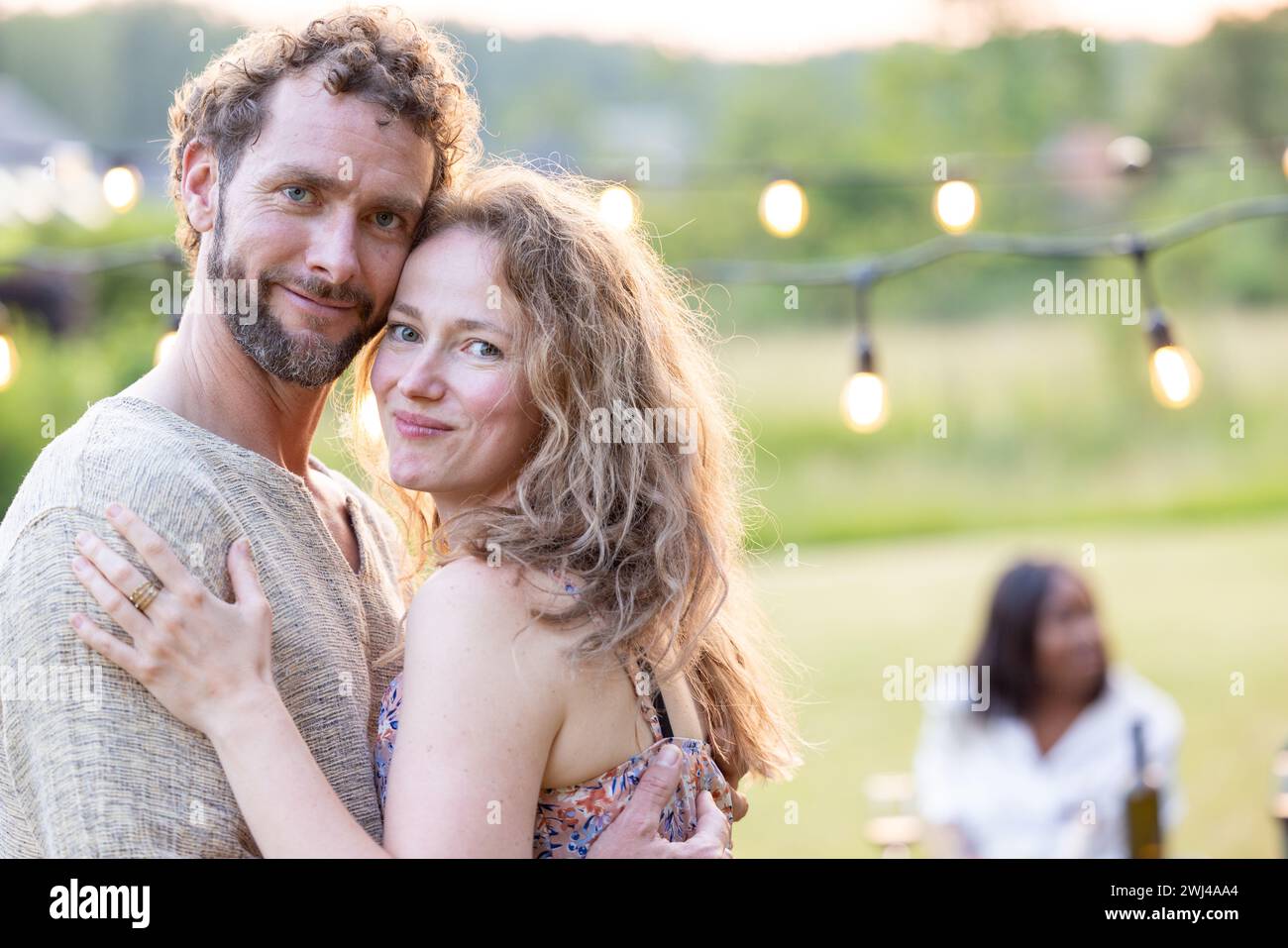 Enchanting Evening: A Couple's Embrace Under the Lights Stock Photo - Alamy