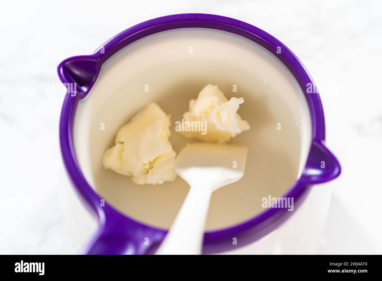 The vegetable shortening is expertly melted for greasing the bundt cake ...