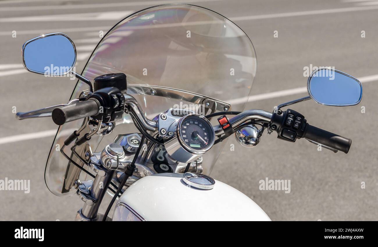 White classic motorcycle chopper on a city street close up Stock Photo ...