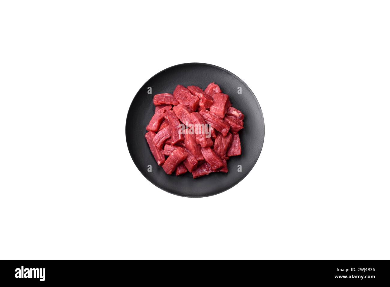 Raw organic meat beef or lamb cut into slices with salt, spices and ...
