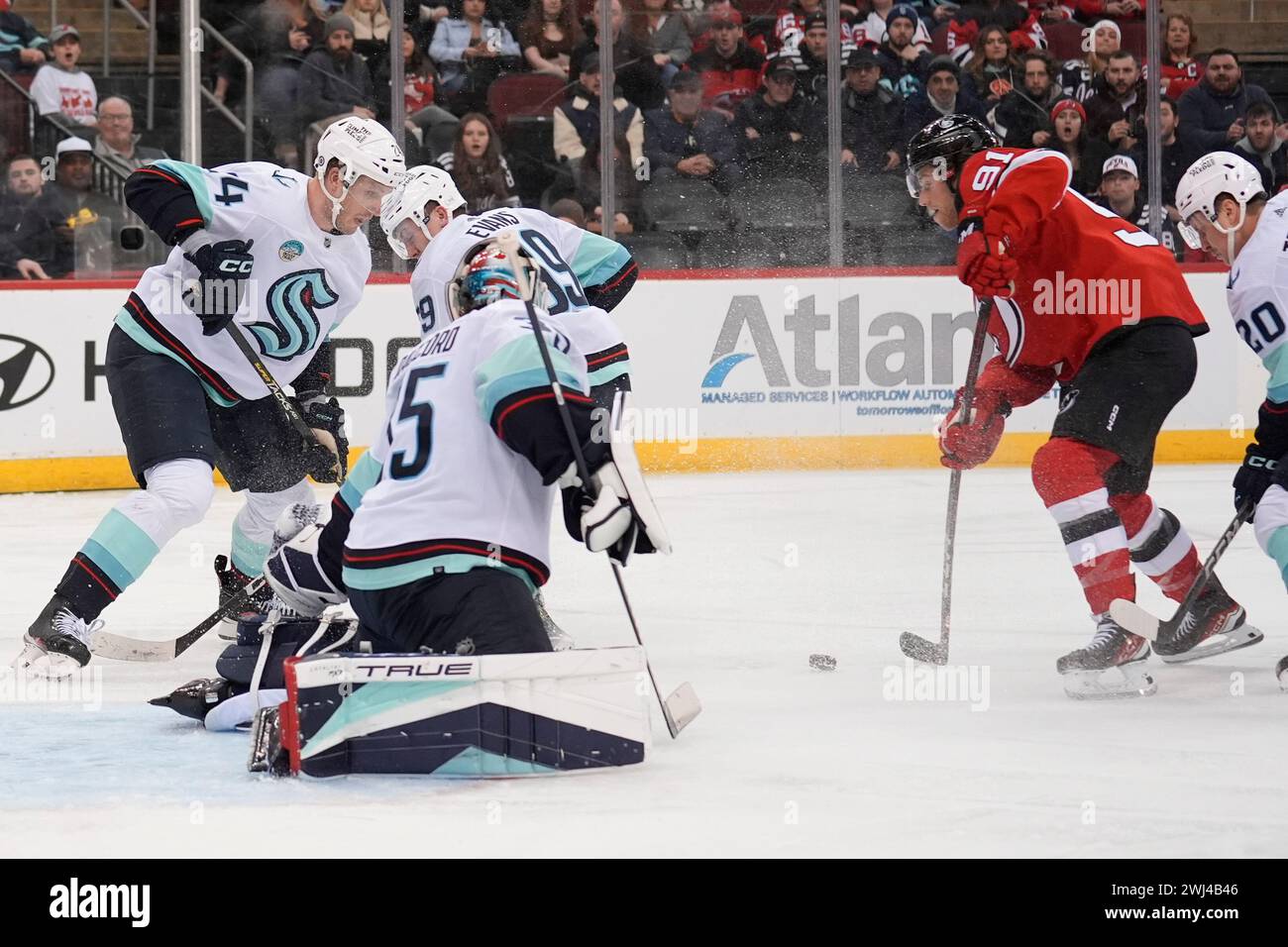 New Jersey Devils' Dawson Mercer, right, scores during the second ...