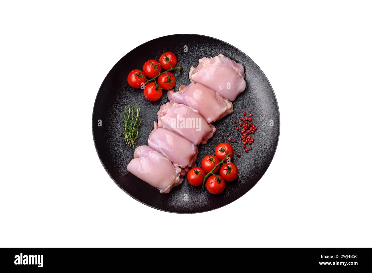 Fresh raw chicken thigh fillets with salt, spices and herbs Stock Photo ...