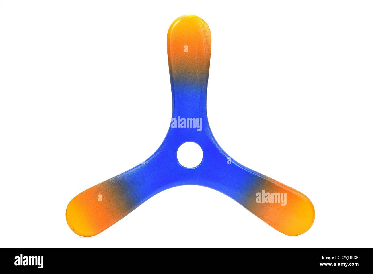 Wooden boomerang painted orange, yellow and blue, isolated on white ...