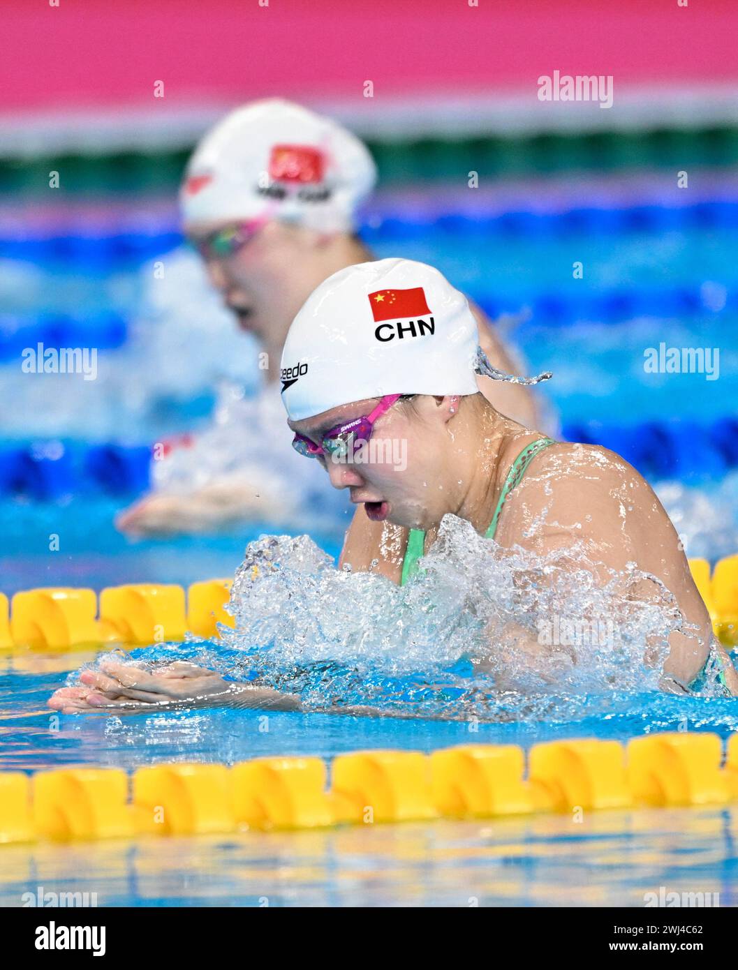 Doha, Qatar. 12th Feb, 2024. Tang Qianting (Front) of China competes ...