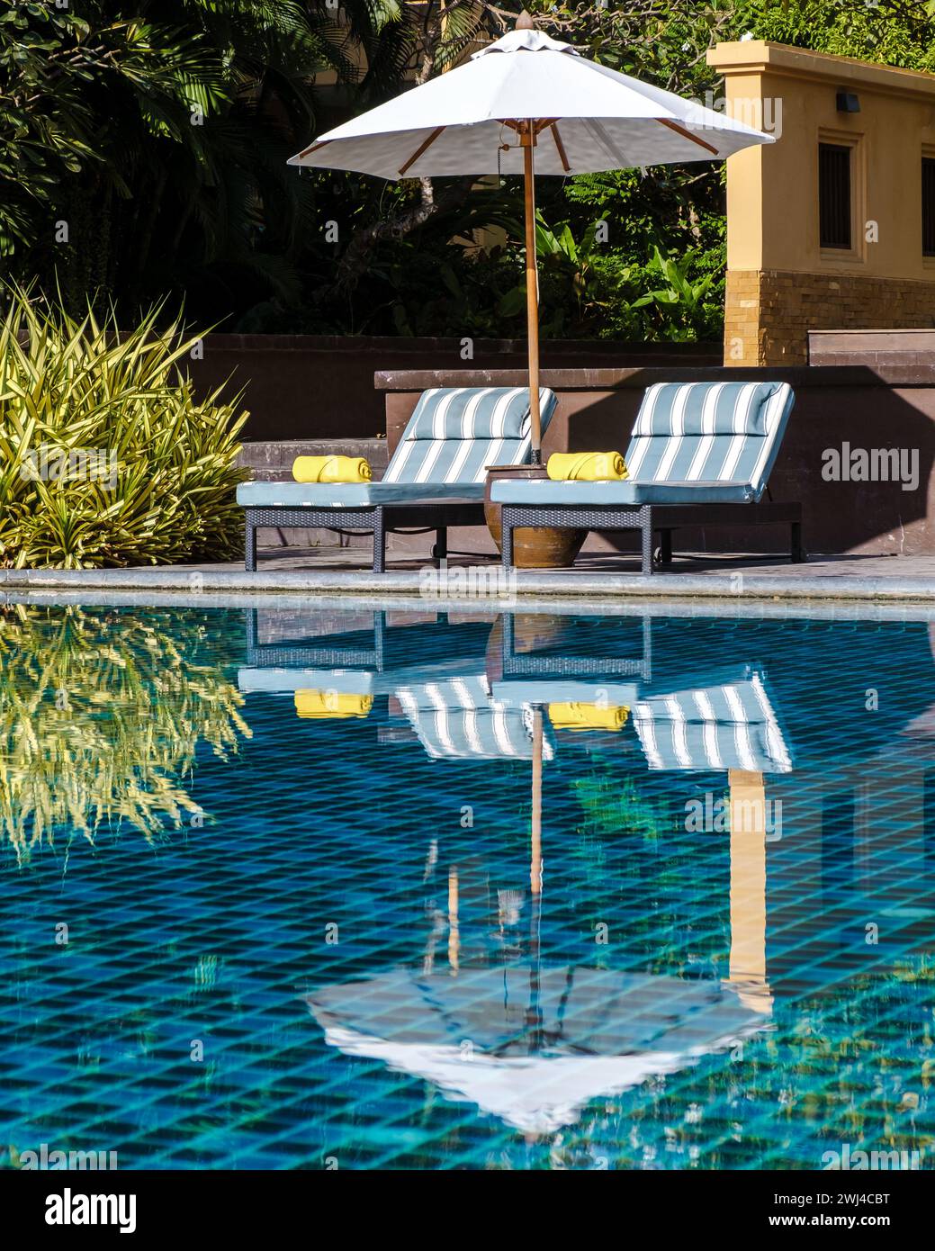 Umbrella and luxury beach chairs by a pool of a luxury hotel Stock ...