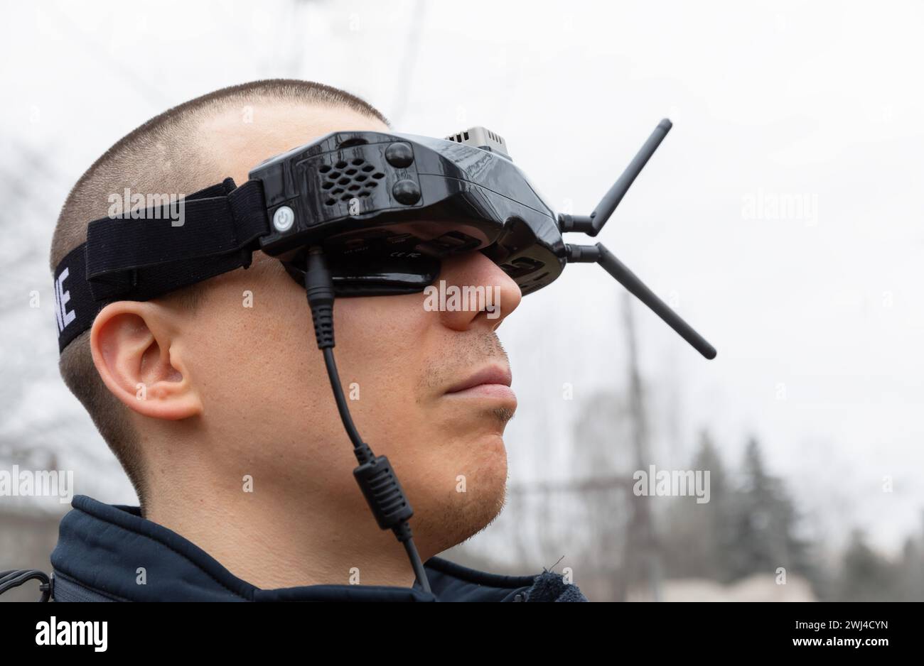 A young man is seen wearing virtual reality goggles during a FPV drone ...