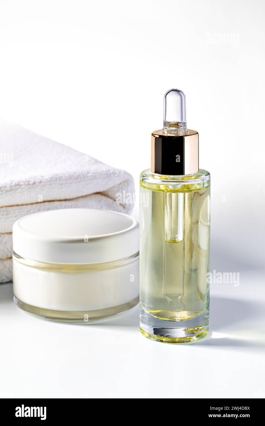 Essential serum Oil in cosmetic bottles with dropper Stock Photo - Alamy